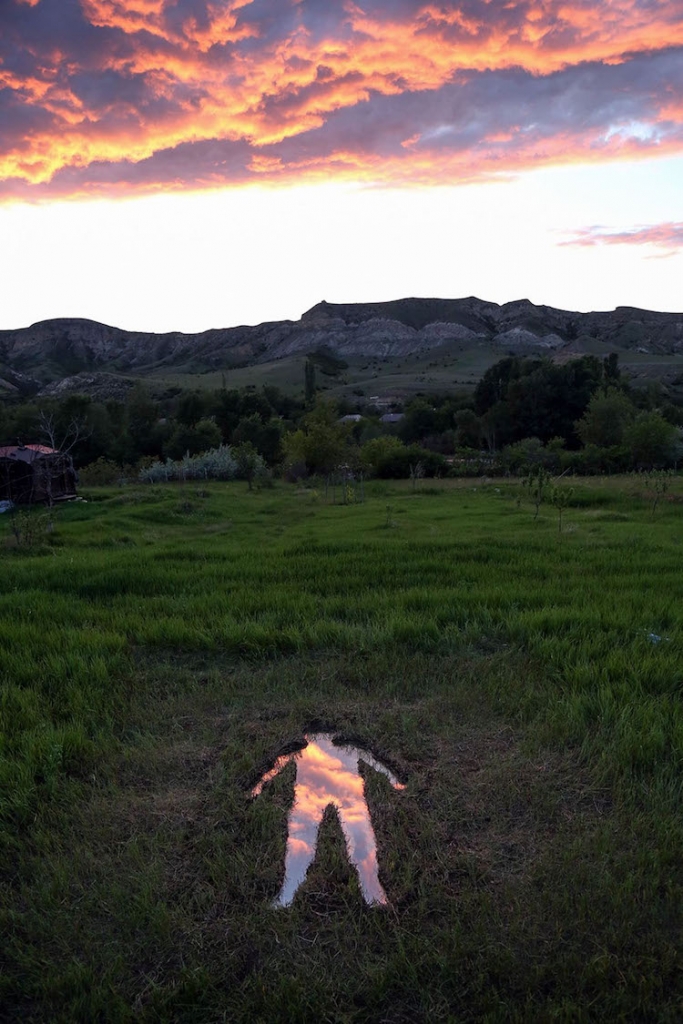 Human-Shaped “Pool” Lies in a Field, Reflecting the Ever-Changing Sky ...