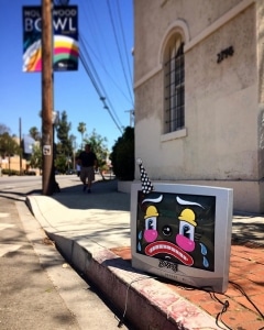 Street Artist Paints Sad Clown Faces onto Discarded Furniture