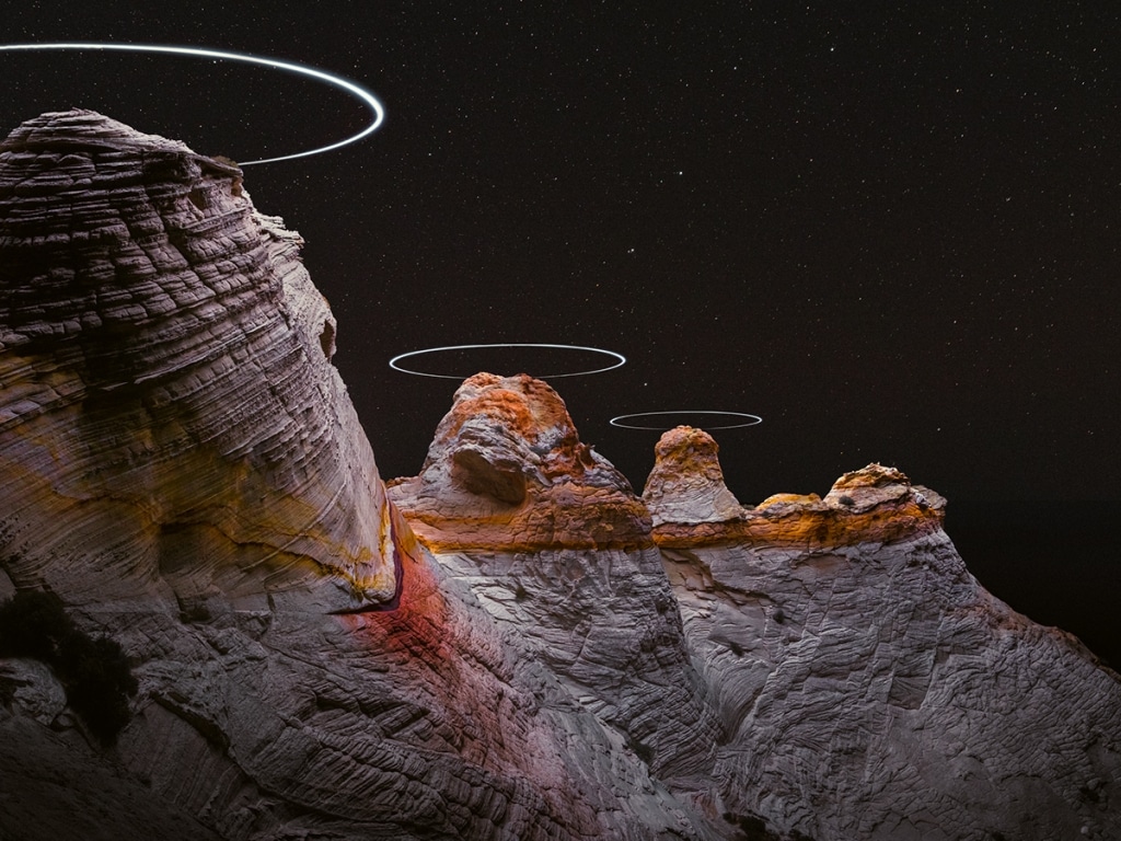 Long Exposure Drone Photographs Create Light Halos Over Mountains