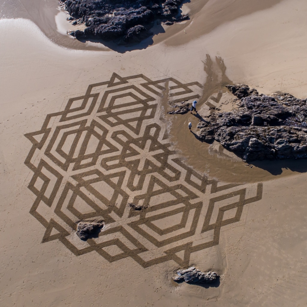 Artist Walks Along Shores To Create Massive Sand Designs Before High ...