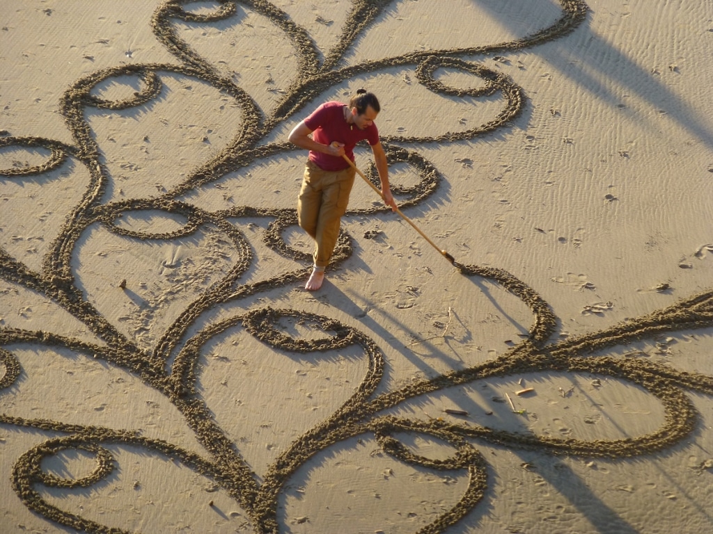Artist Walks Along Shores To Create Massive Sand Designs Before High ...