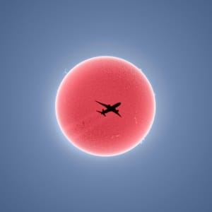 Photographer Accidentally Captures Plane Flying Over Sun