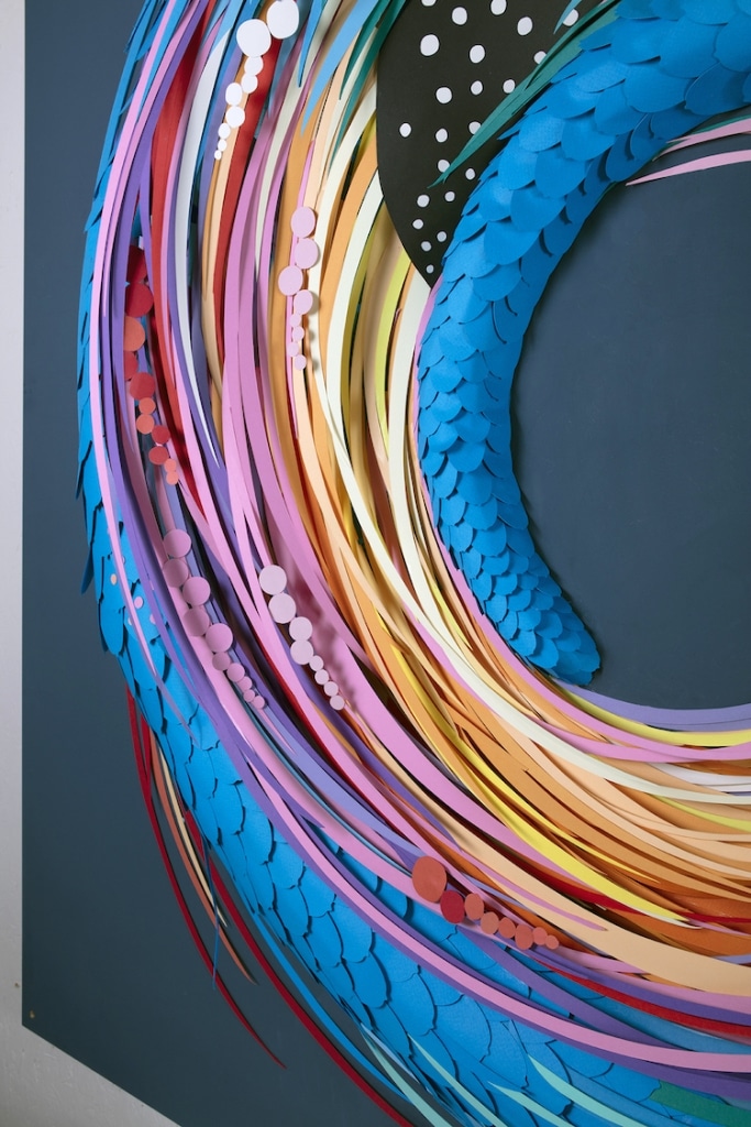 Numerous Strips of Colorful Paper Capture the Energy of Birds in Motion