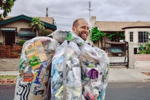 Man Wears a Custom Suit Showing All the Trash He Produced in a Month