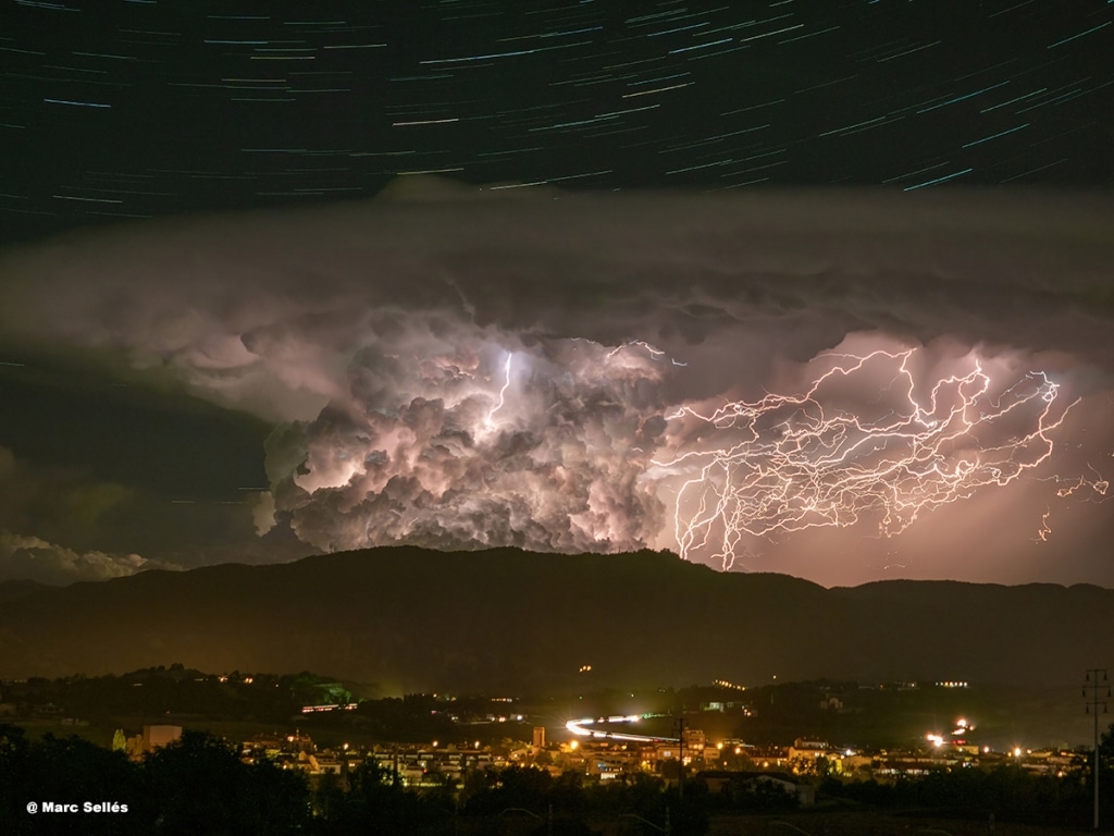 Magical Photo of Lightning Storm with Star Trails Swirling Overhead