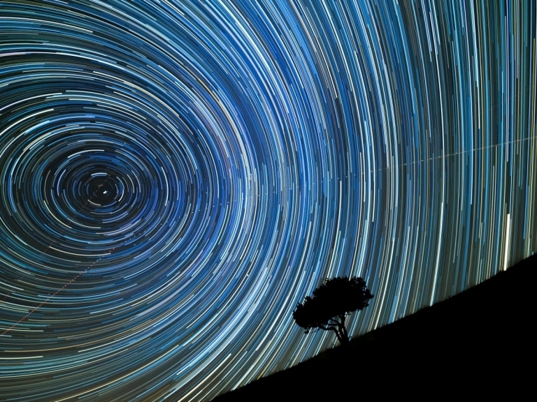 Magical Photo of Lightning Storm with Star Trails Swirling Overhead