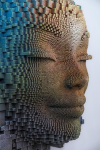 Enigmatic Faces Emerge in Pixelated Forms in Exciting Sculpture