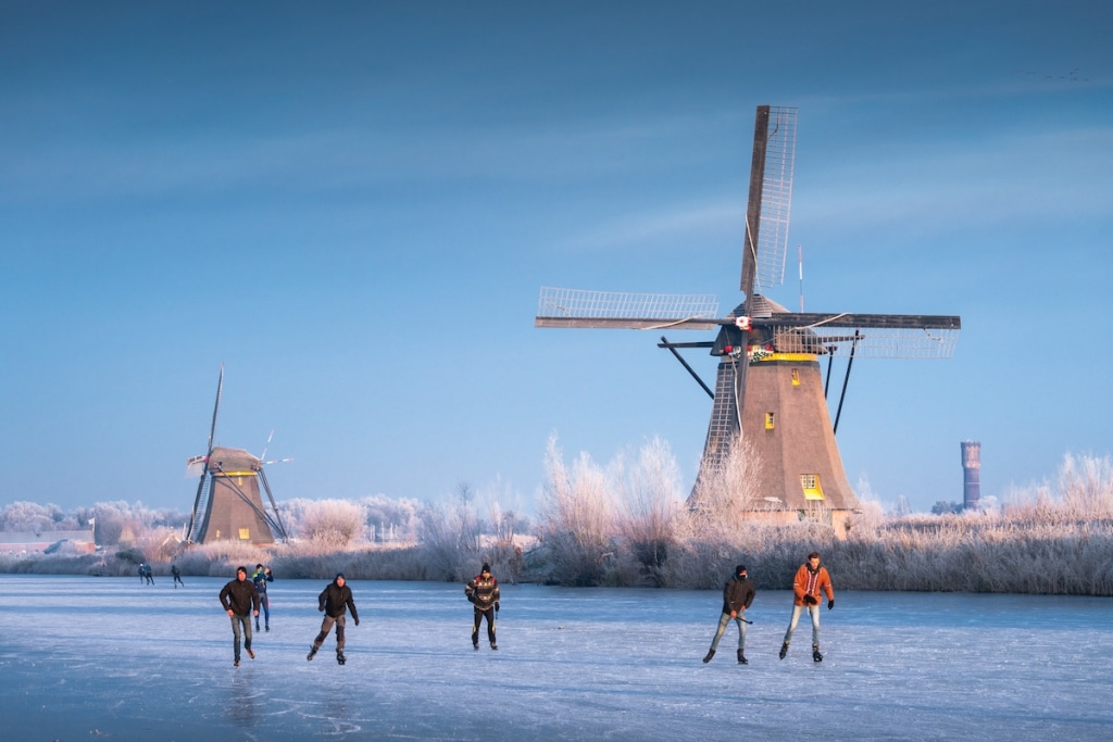 Photographer Captures Enchanting Ice Skating Among Windmills