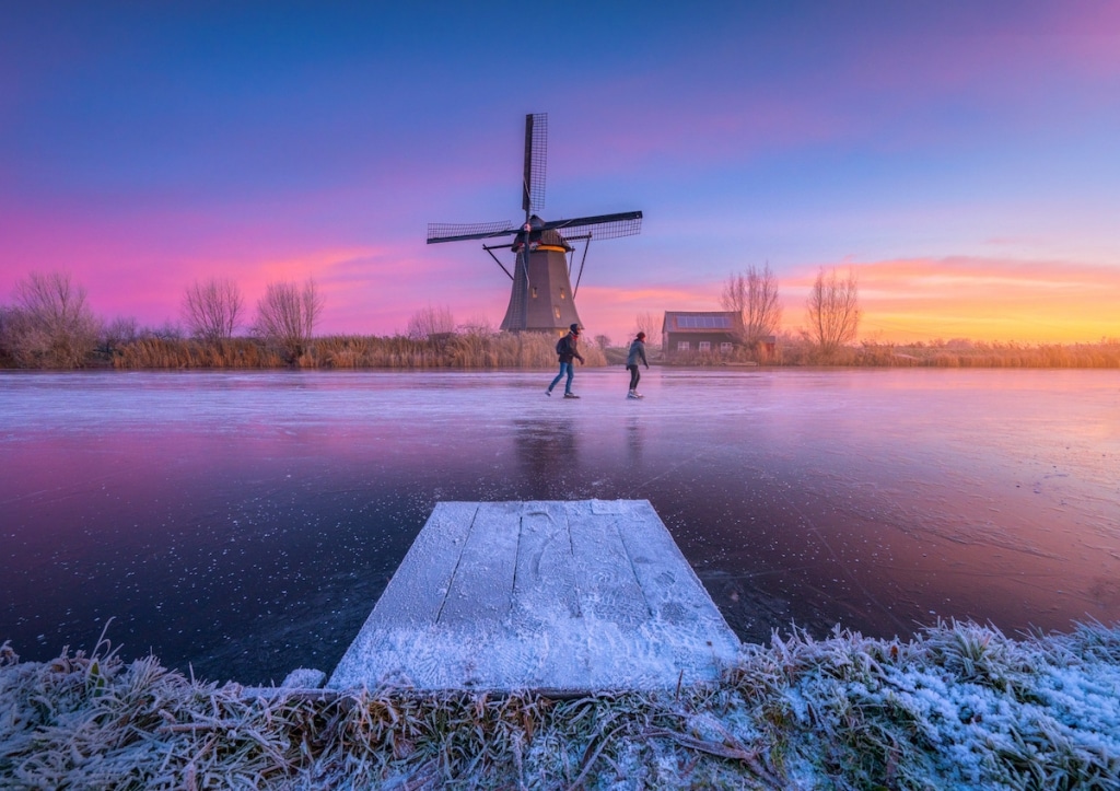 Photographer Captures Enchanting Ice Skating Among Windmills