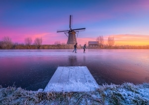 Photographer Captures Enchanting Ice Skating Among Windmills