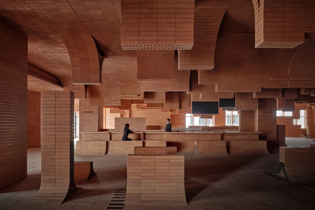 Cinema-Coffee Bar Reimagines Bricks as Rolling Ocean Waves